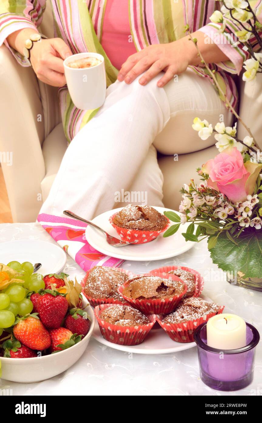 Detail of a set coffee table and the visitor's legs Stock Photo - Alamy
