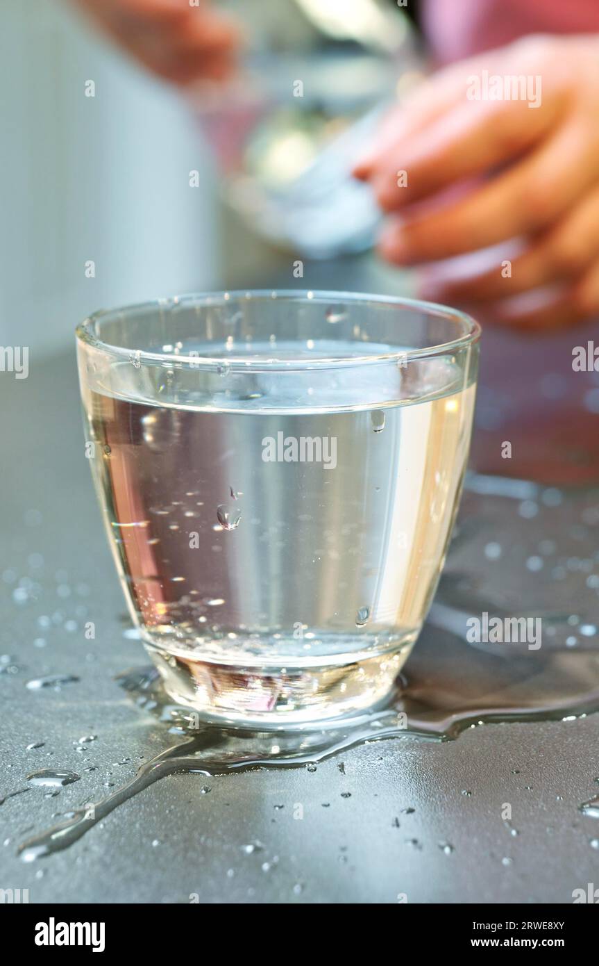 Hand reaches for the filled glass Stock Photo - Alamy