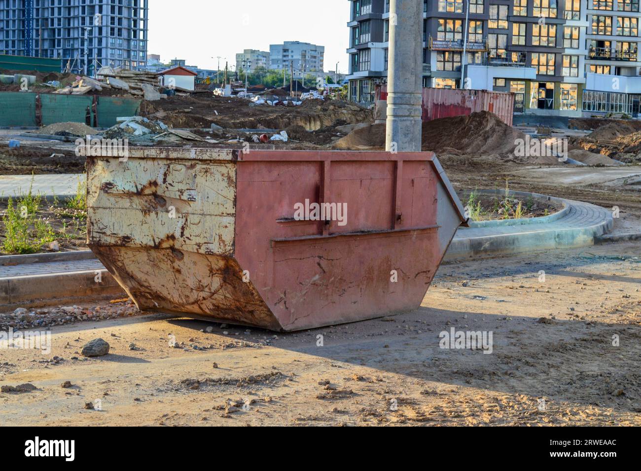 a large, rusty and pink dumpster for construction waste. a container ...