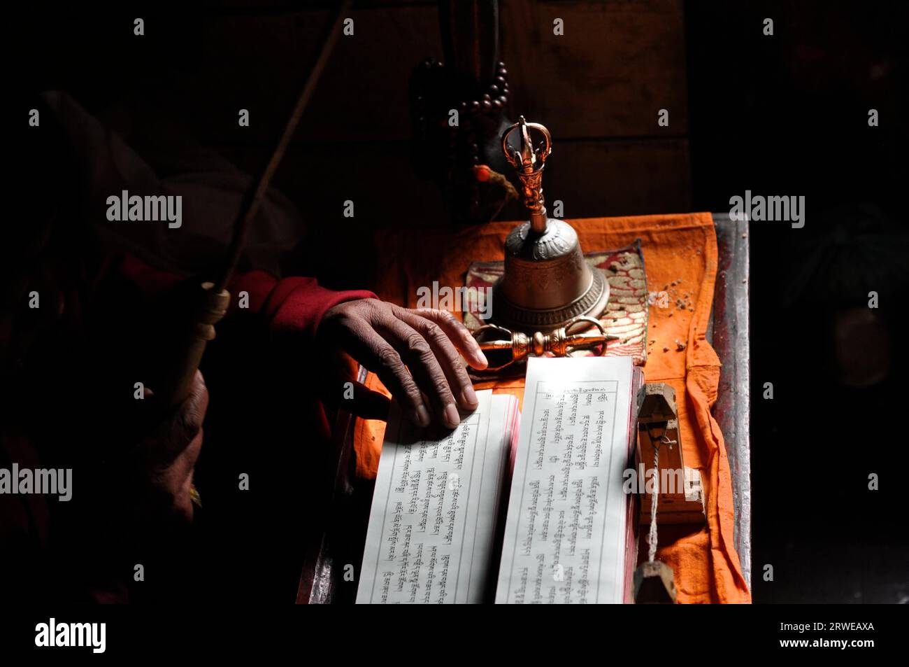 A monk in Lamayuru monastery sitting behind a desk Stock Photo - Alamy