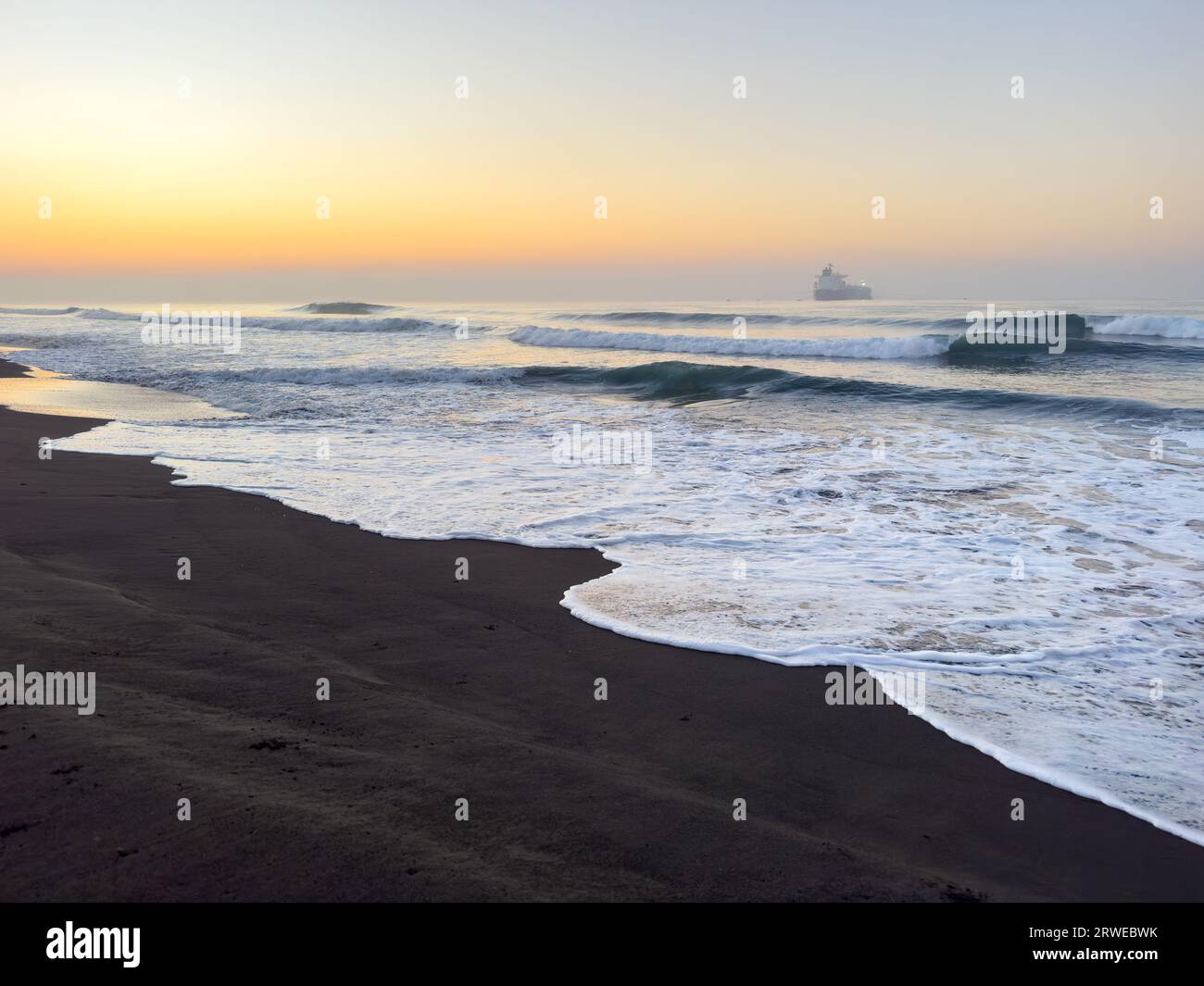 Beautiful sunrise over the black sand beach of Port of San Jose in ...