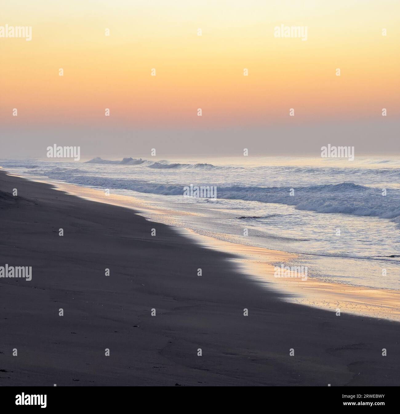 Beautiful sunrise over the black sand beach of Port of San Jose in ...