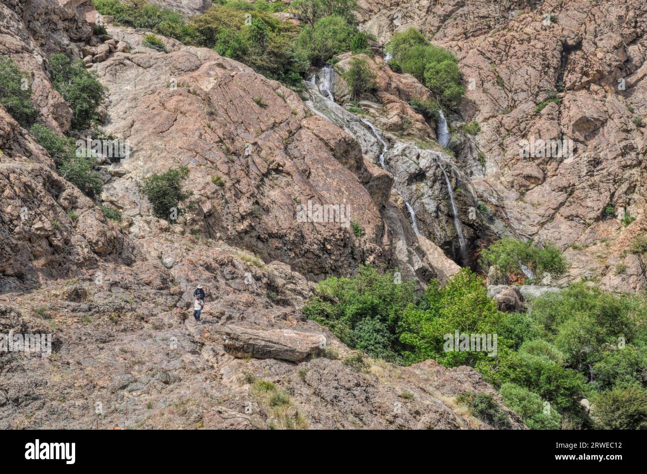 Water cascading down the scenic rocky slopes in Tochal, Iran Stock ...