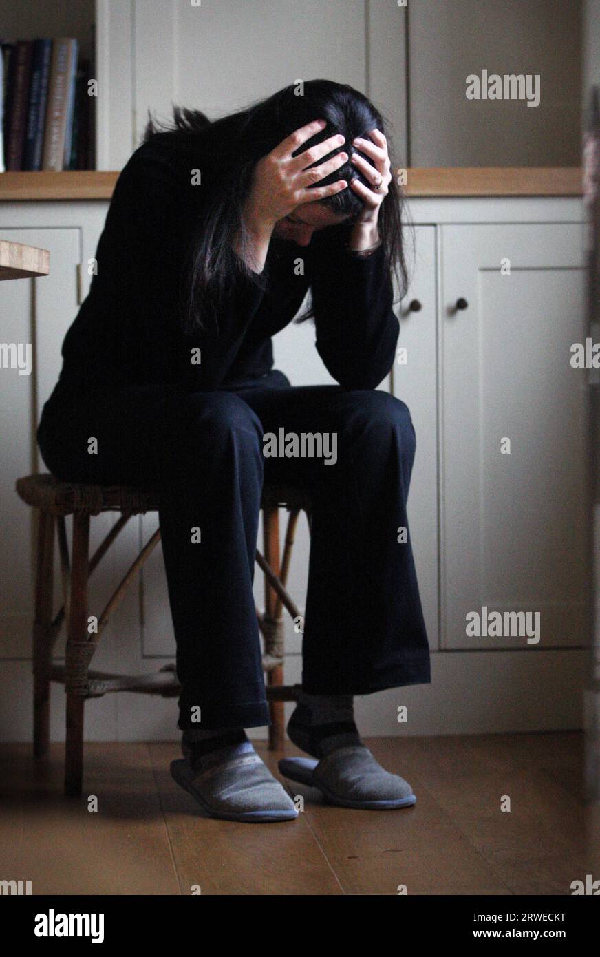PA file photo of a woman sitting with her head in her hands - picture ...