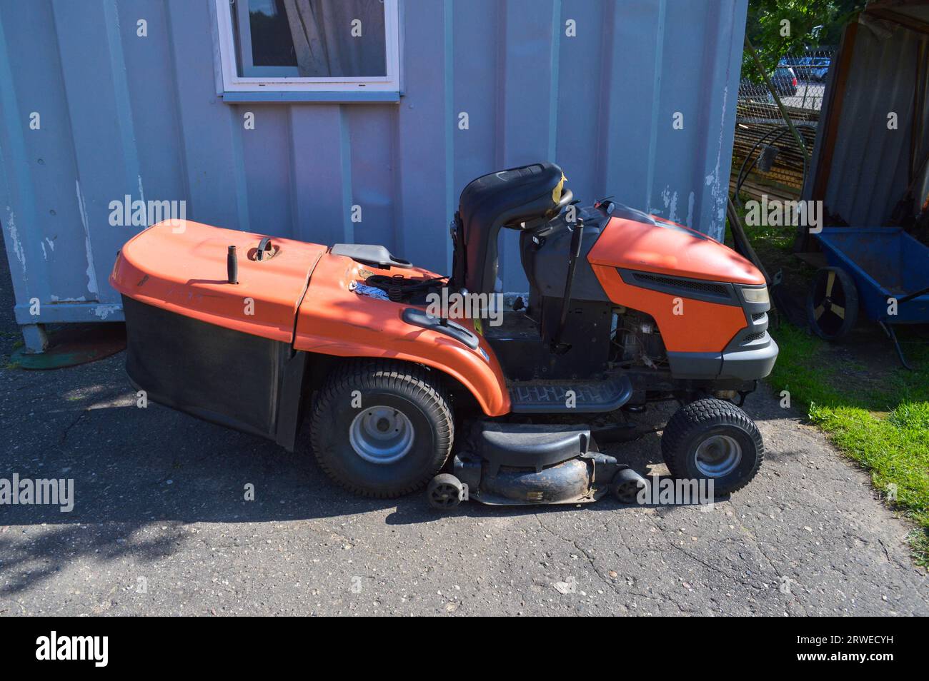 New modern red four-wheel lawn mower for mowing grass, lawn ...