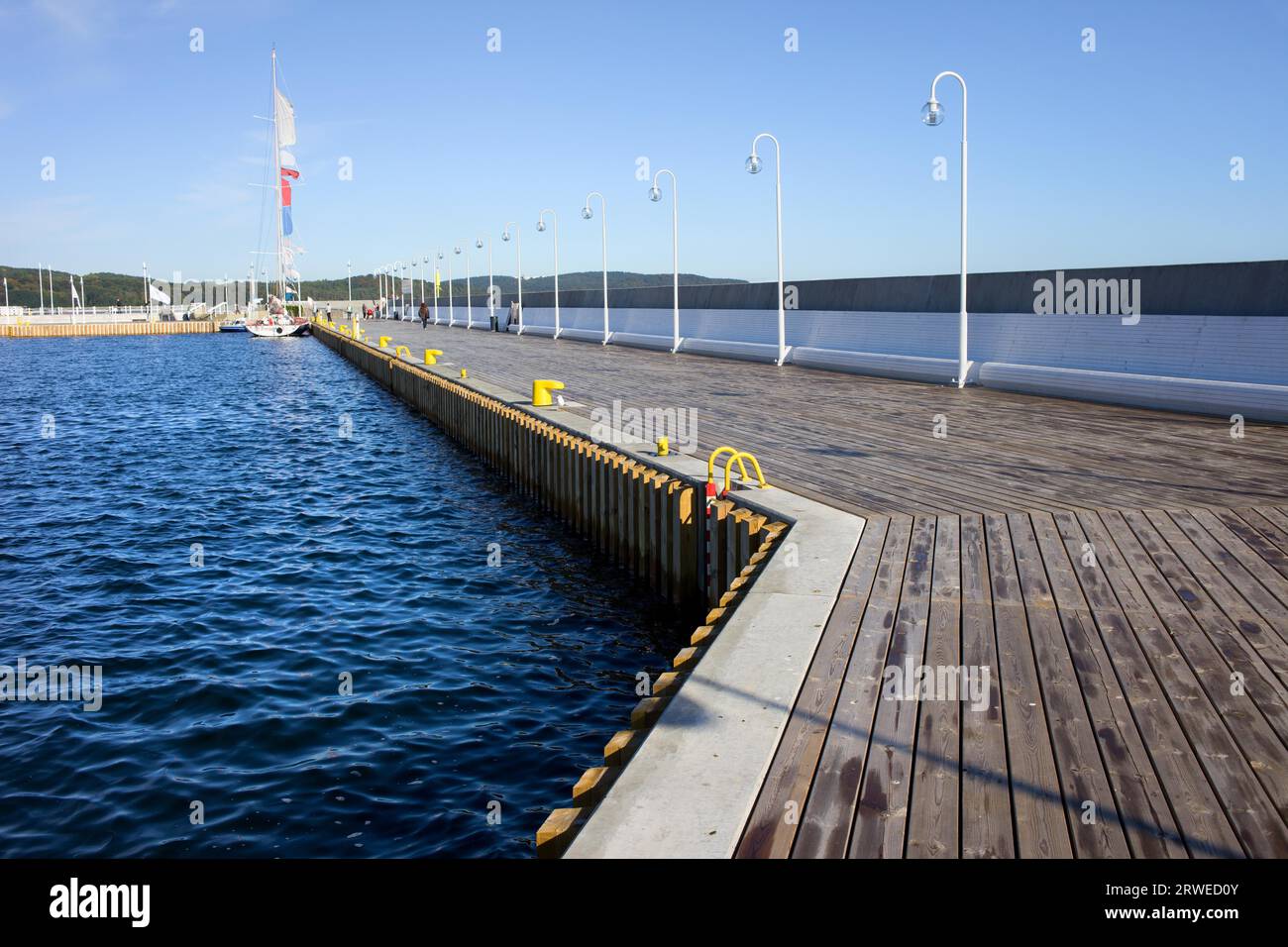 Large long marina sea pier with wooden planks and concrete frame Stock ...