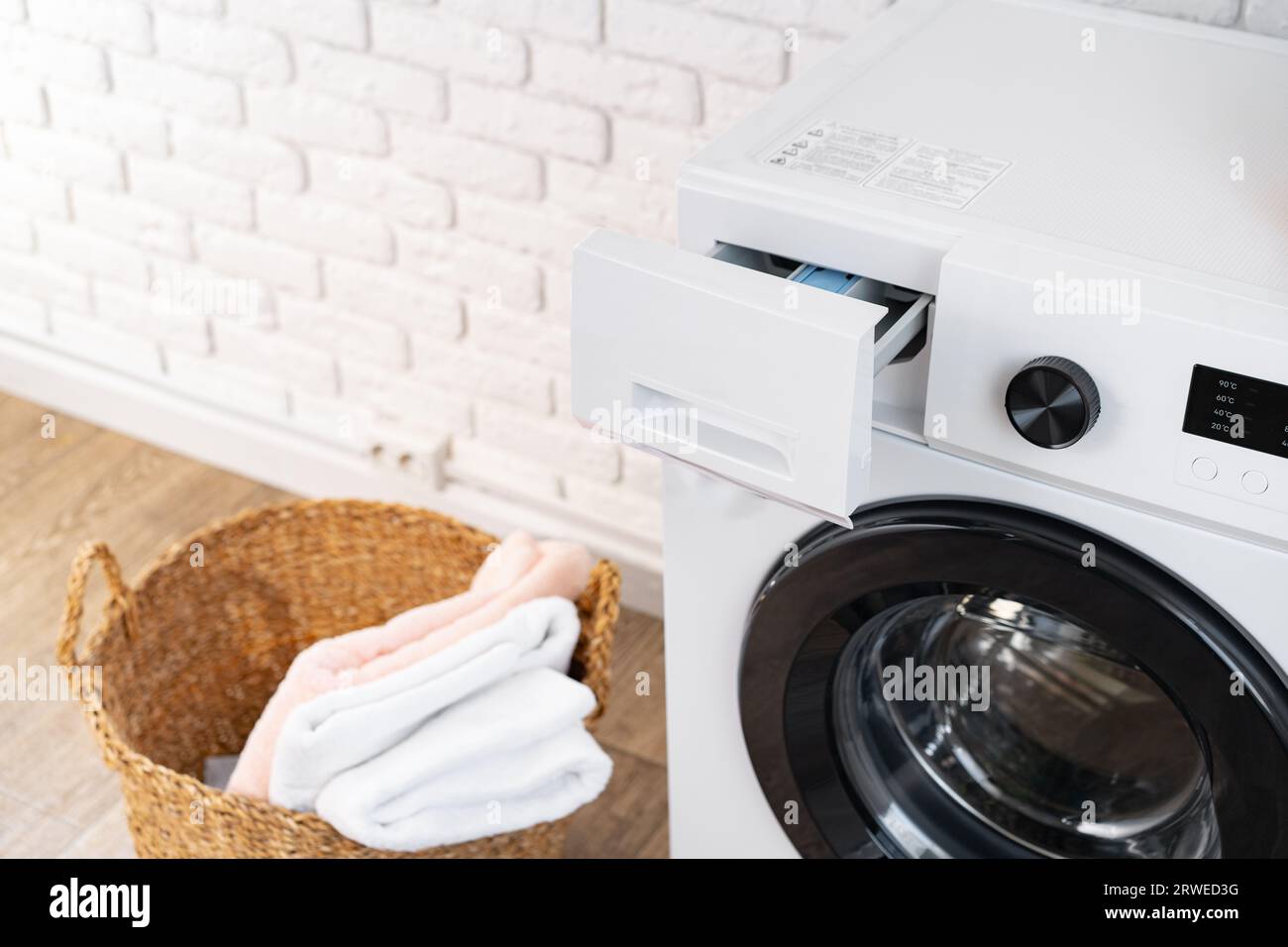 Washing machine and basket in a laundry room Stock Photo - Alamy