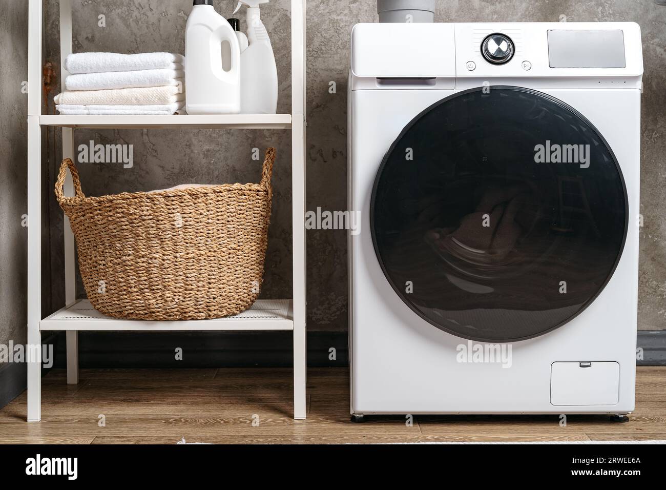 Washing machine in a gray modern laundry room Stock Photo - Alamy