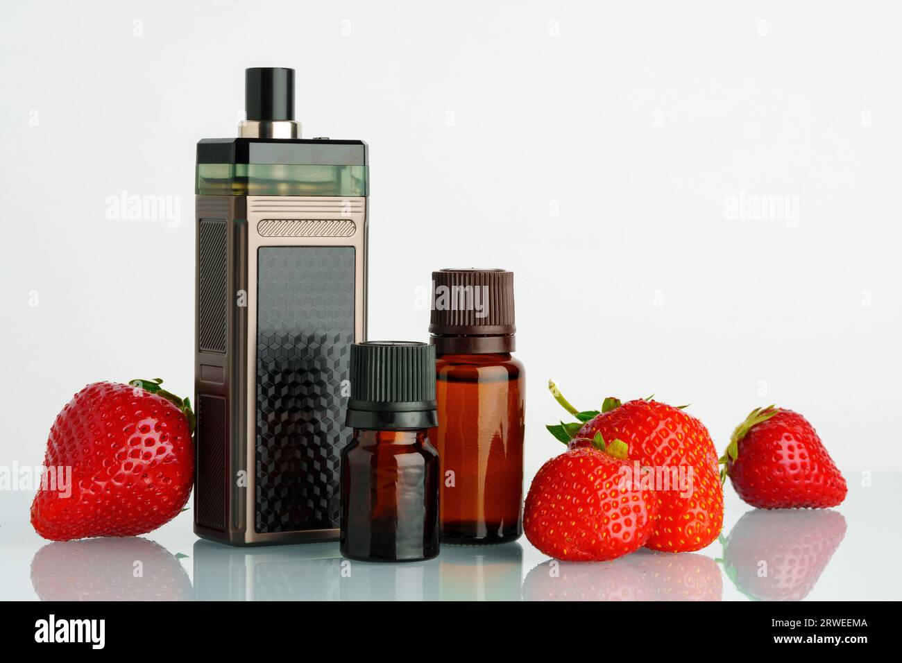 Electronic cigarette liquid with strawberry flavor on white background ...