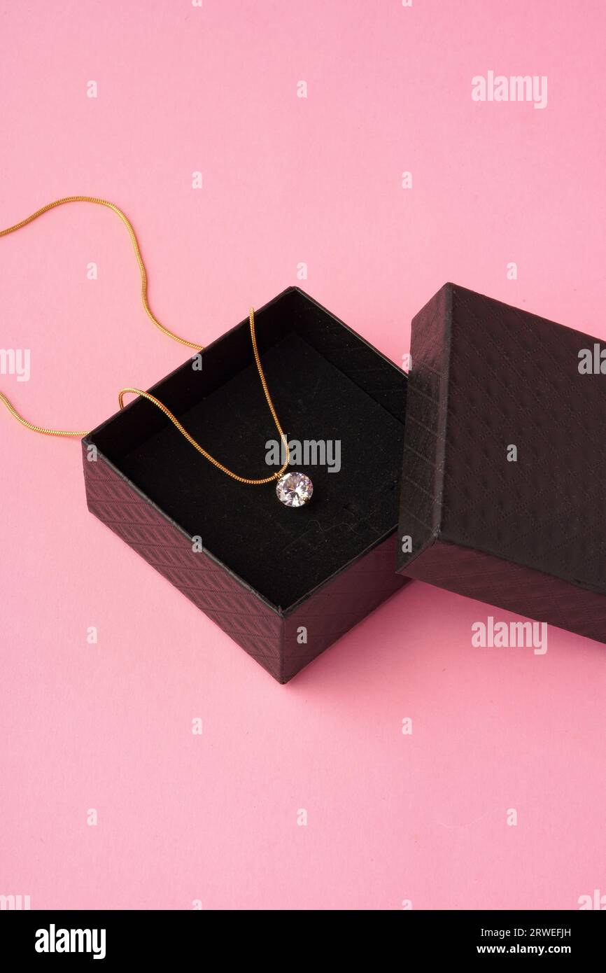 Small jewelry box on pink studio background Stock Photo - Alamy