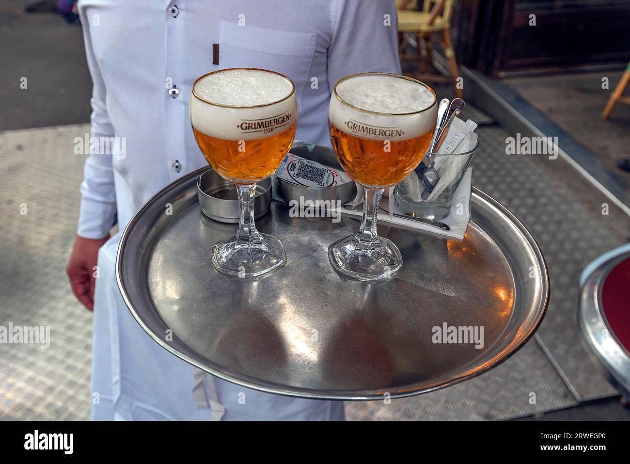 Waiter brings two beers on a tray, Paris, France Stock Photo - Alamy