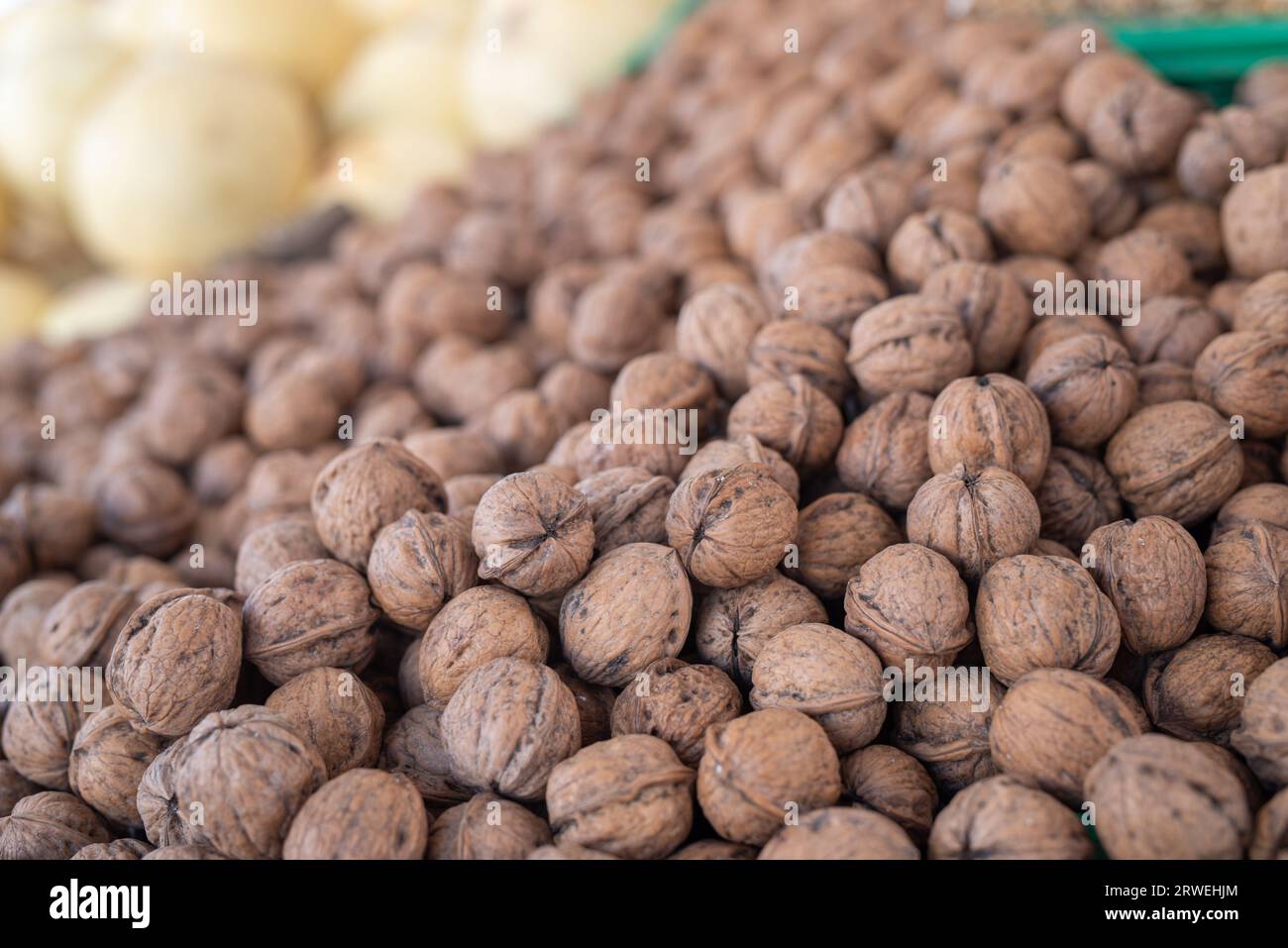 Walnuts in shell on stand of food market Stock Photo - Alamy