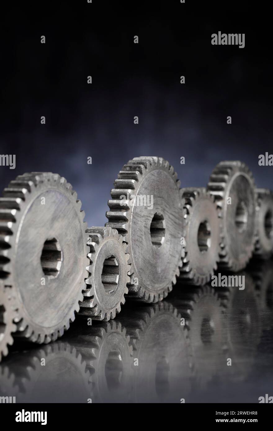 Old metallic cog gears in a row Stock Photo - Alamy