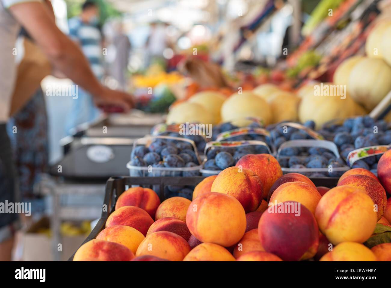 Fresh fruit on stand of food market with blurred background Stock Photo ...