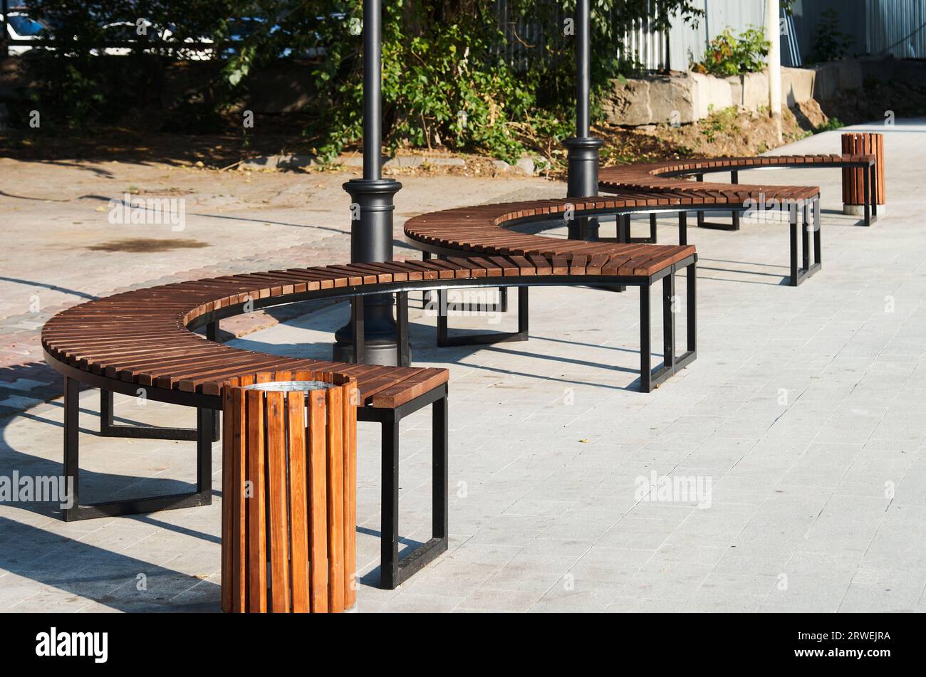 Semicircular wooden benches on a city street Stock Photo - Alamy