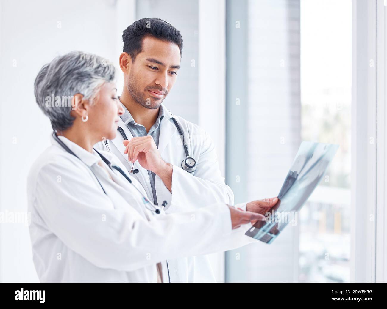 Window, doctors and speaking with scan, healthcare and neurosurgeon ...