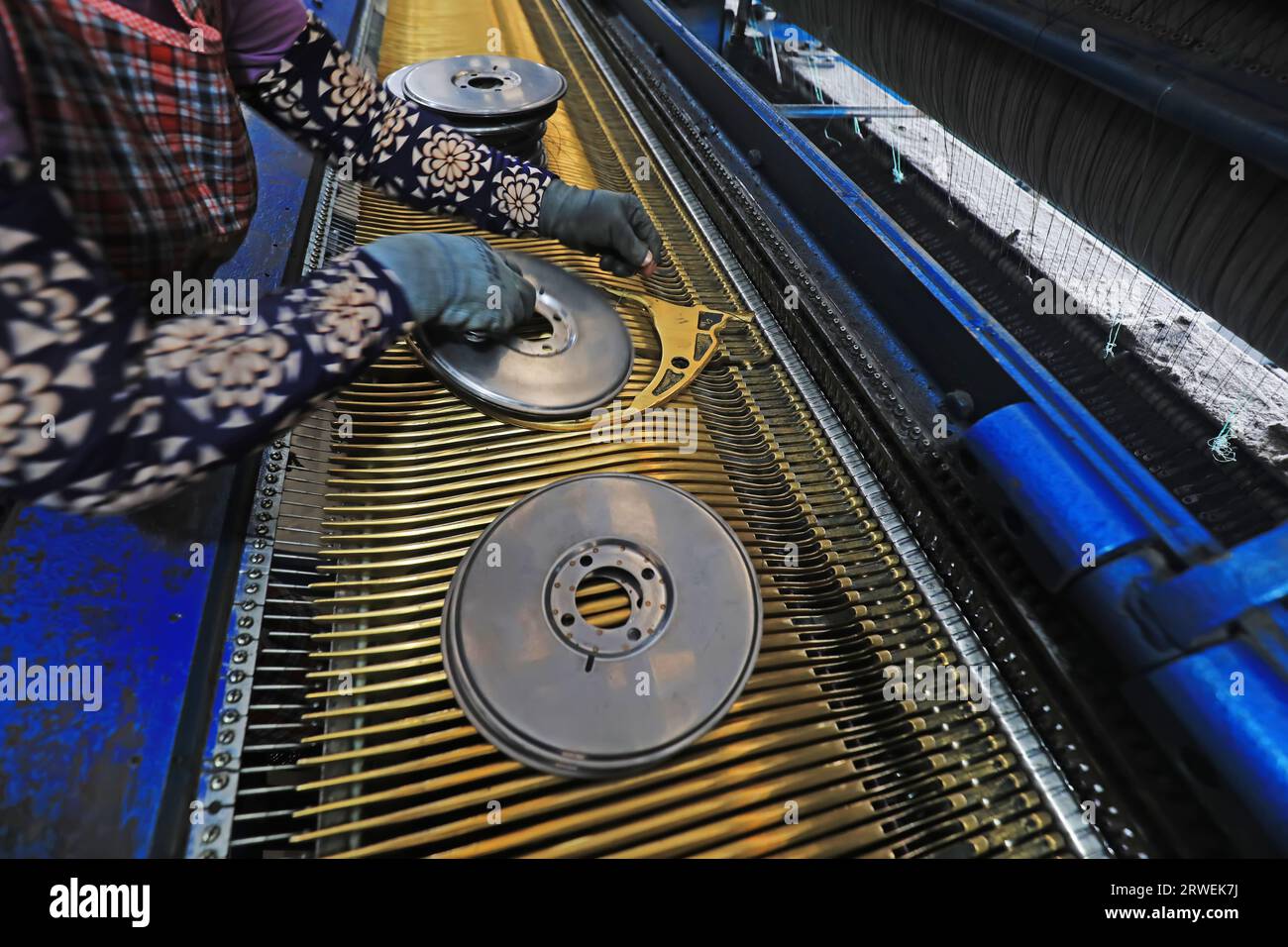 Workers replace shuttle cores at a fishing net processing plant, China ...