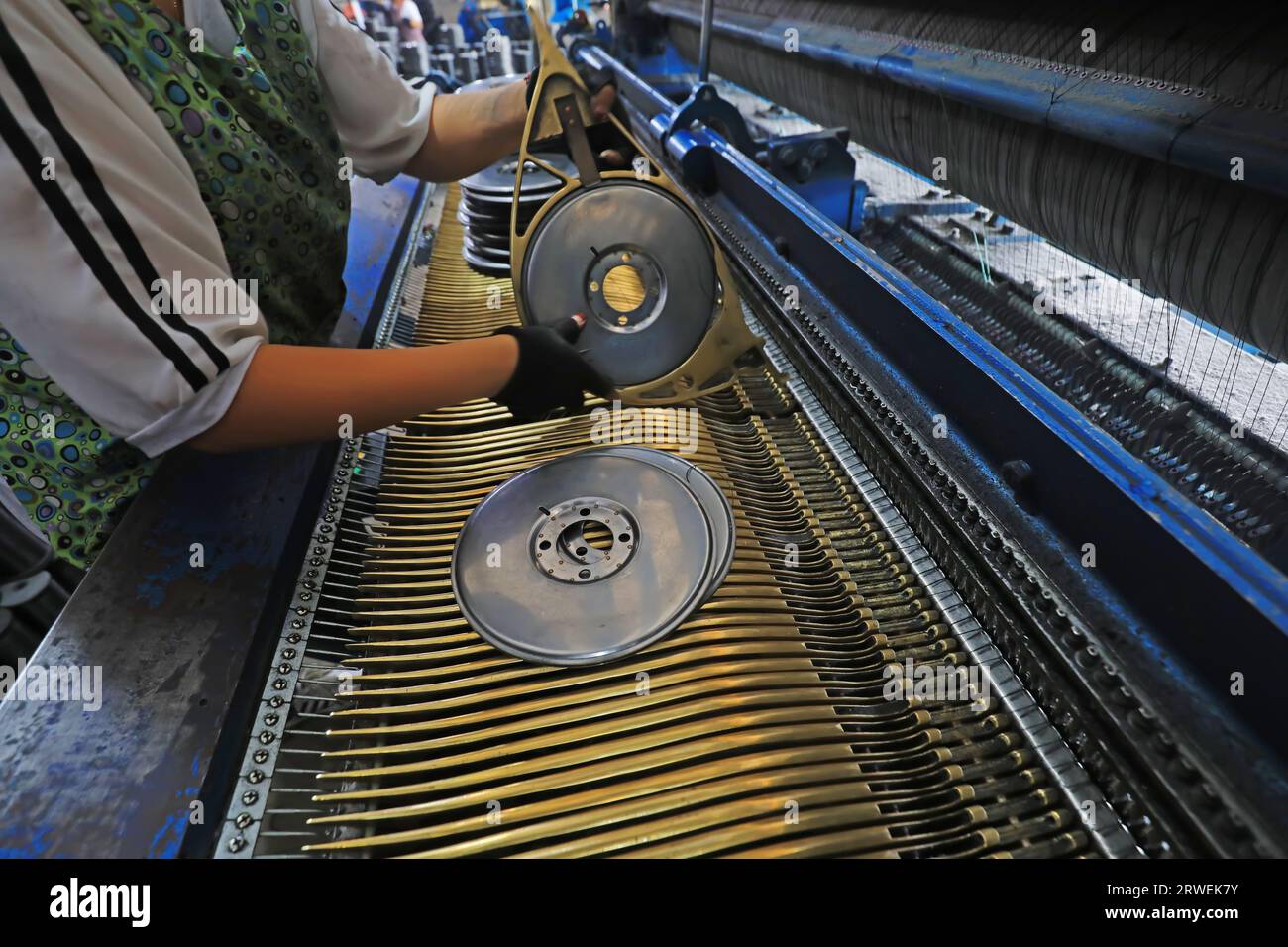 Workers replace shuttle cores at a fishing net processing plant, China ...