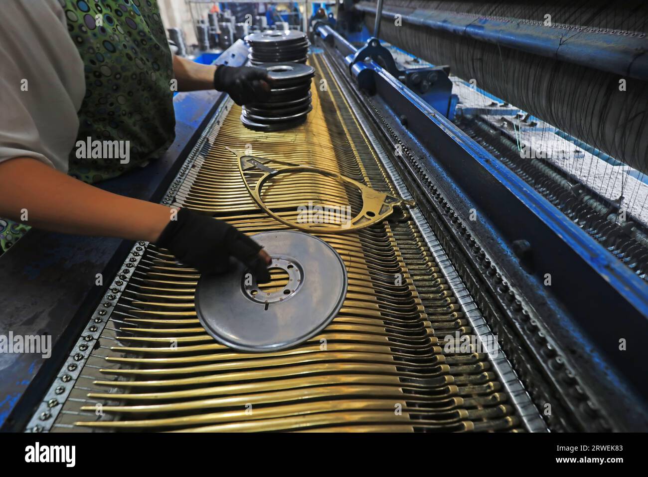 Workers replace shuttle cores at a fishing net processing plant, China ...