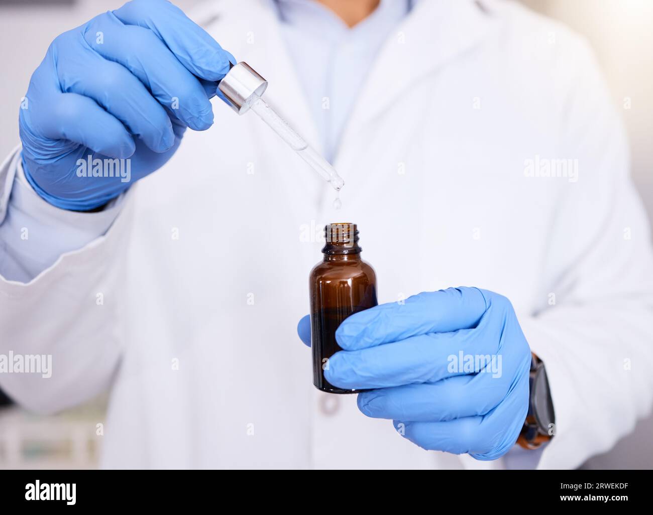 Scientist, hands and pipette with oil for experiment, dosage or ...
