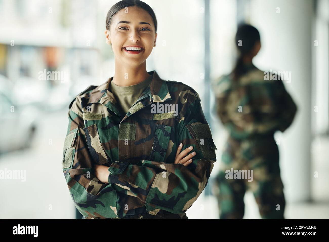 Portrait, soldier and woman with arms crossed, military and security with a smile, confident and ...