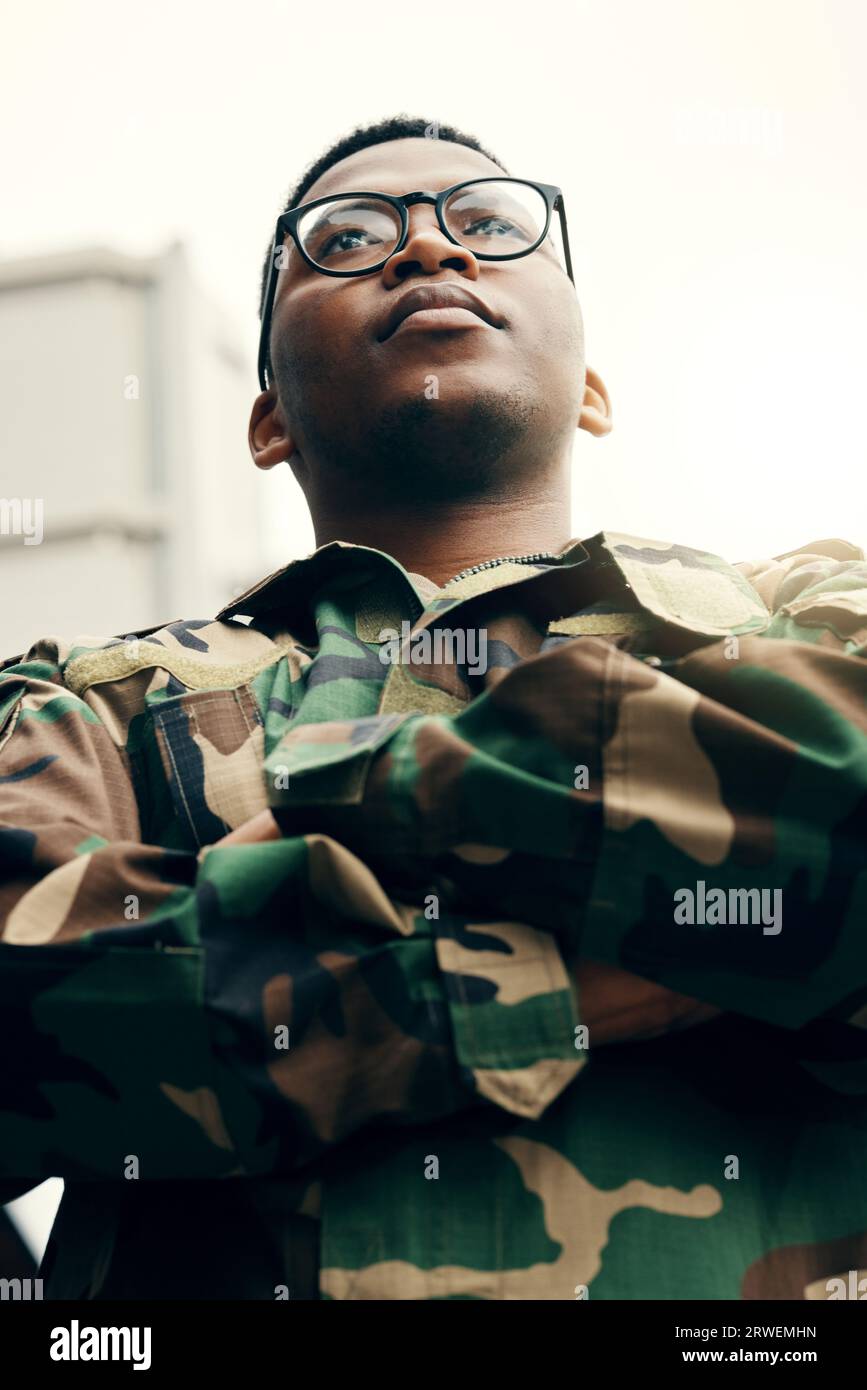 Thinking, outdoor and black man with arms crossed, military and ...