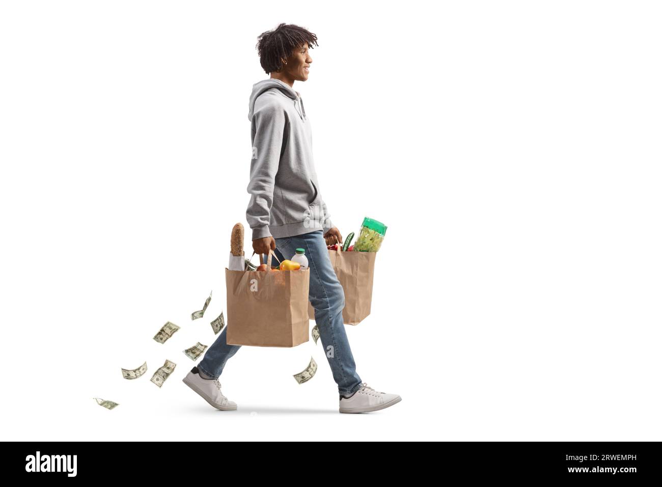Full length profile shot of a young african american man with grocery ...