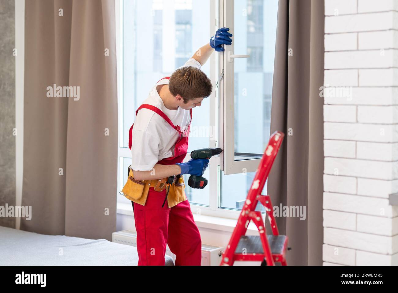 Construction worker installing window in house Stock Photo - Alamy