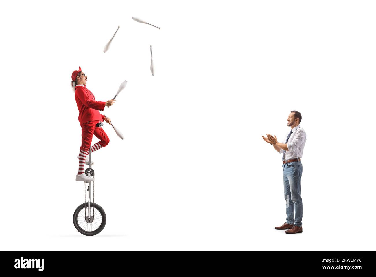 Man giving applause to an acrobat riding a giraffe unicycle and ...