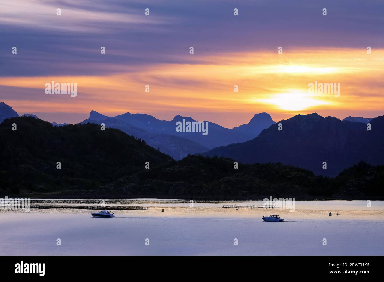 Midsummer sun on the sky in the fjord Vestfjorden near the Lofoten ...