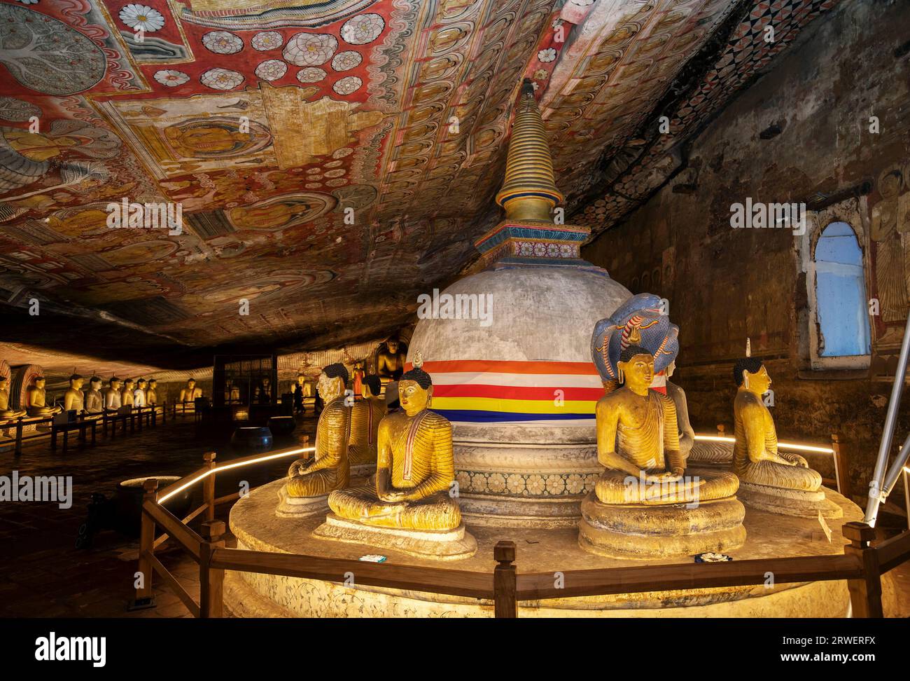 The spectacular interior of Cave Two (Maharaja Viharaya) including a stupa surrounded by seated ...