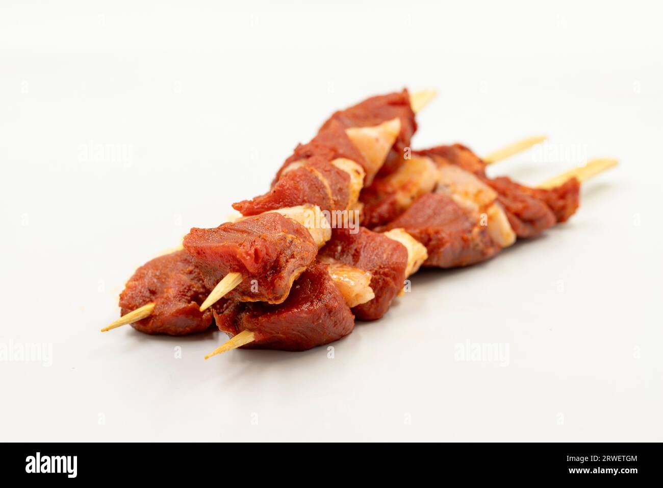 Beef tenderloin skewer isolated on white background. Beef tenderloin skewer with raw sauce with ...