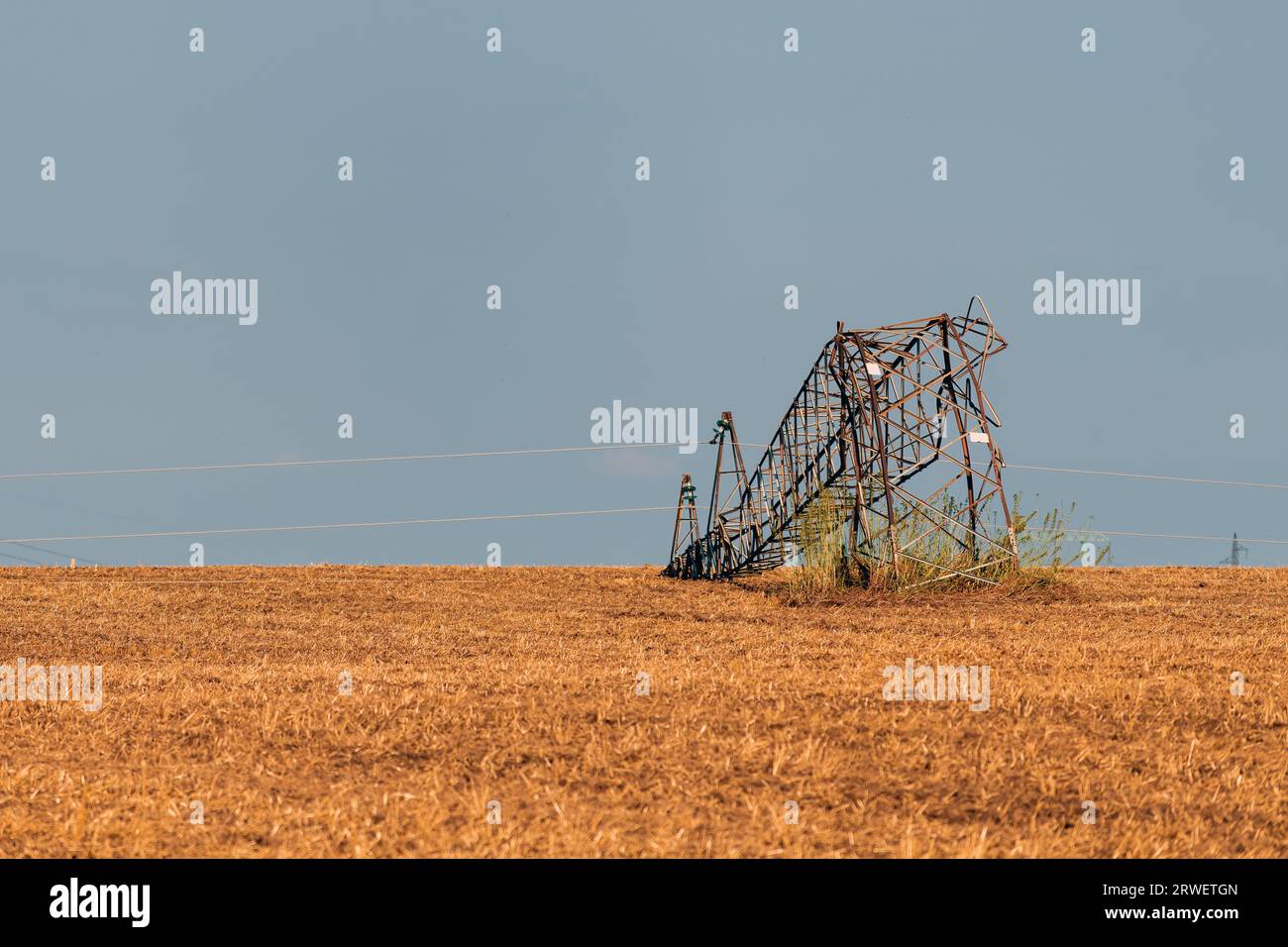Bent over electricity pylon after strong summer storm, climate change ...