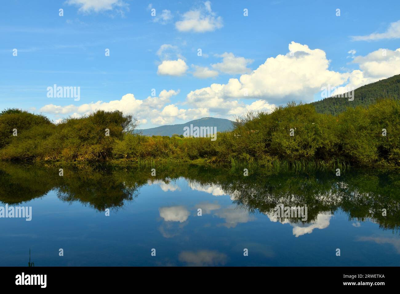 View of Stržen river at lake Cerknica and Slivnica hill in the ...