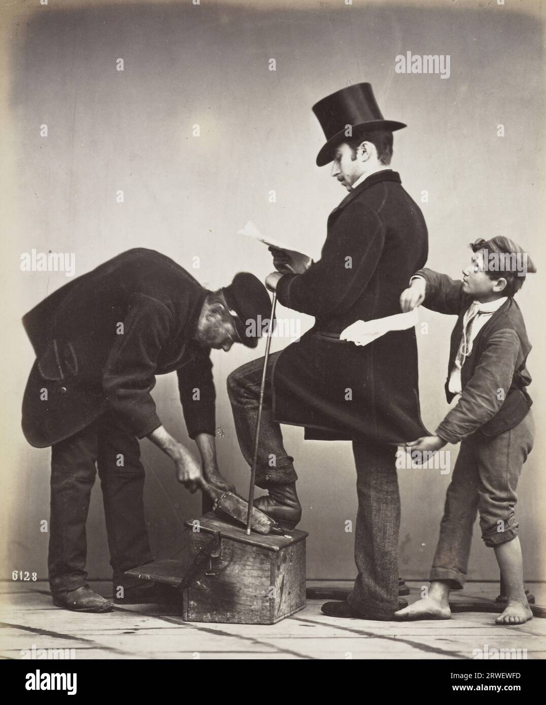 Pickpocket at work, While a shoeshine boy distracts the victim, a boy ...