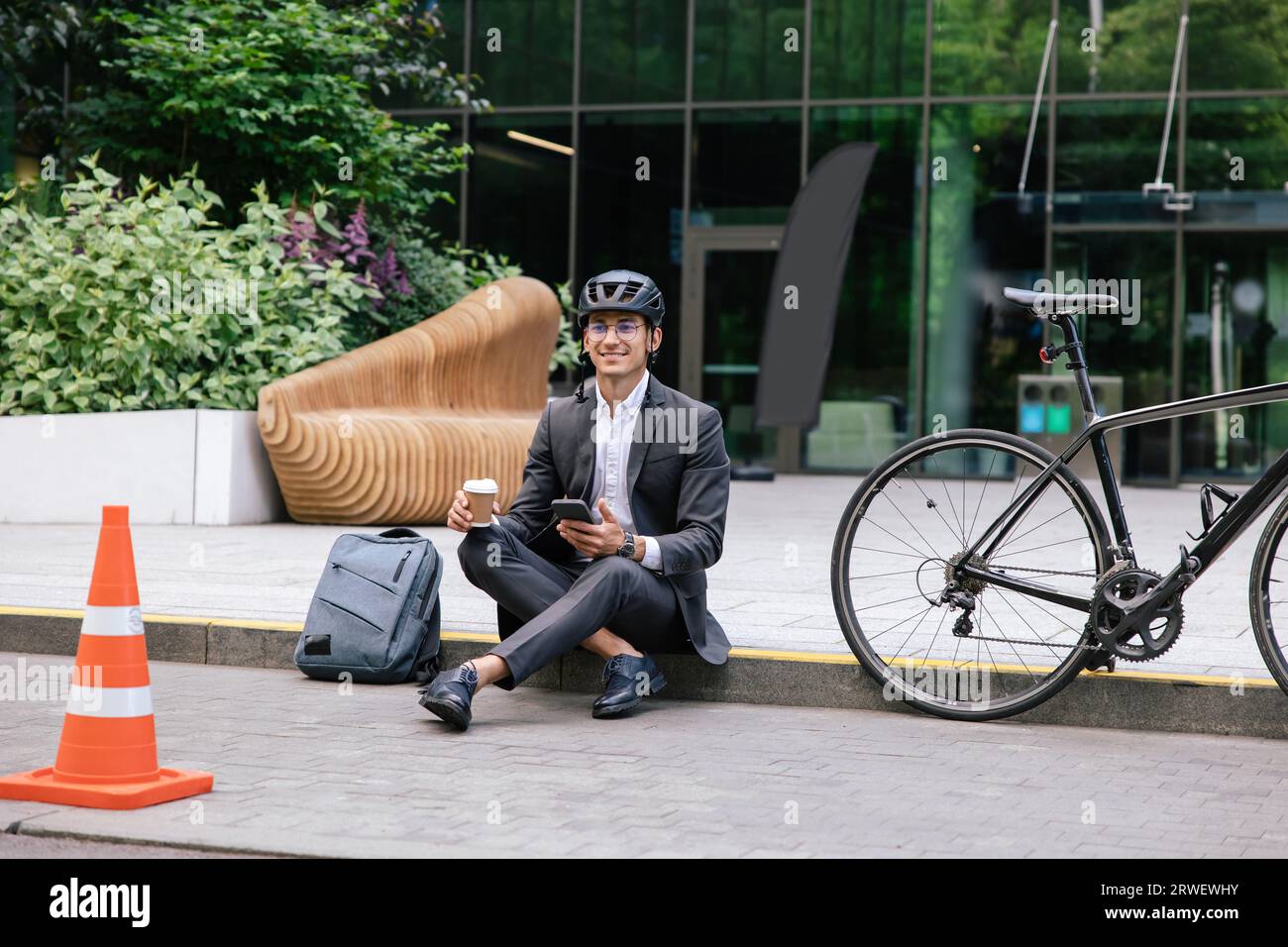 Young man having coffee after commuting to the office by bike Stock ...