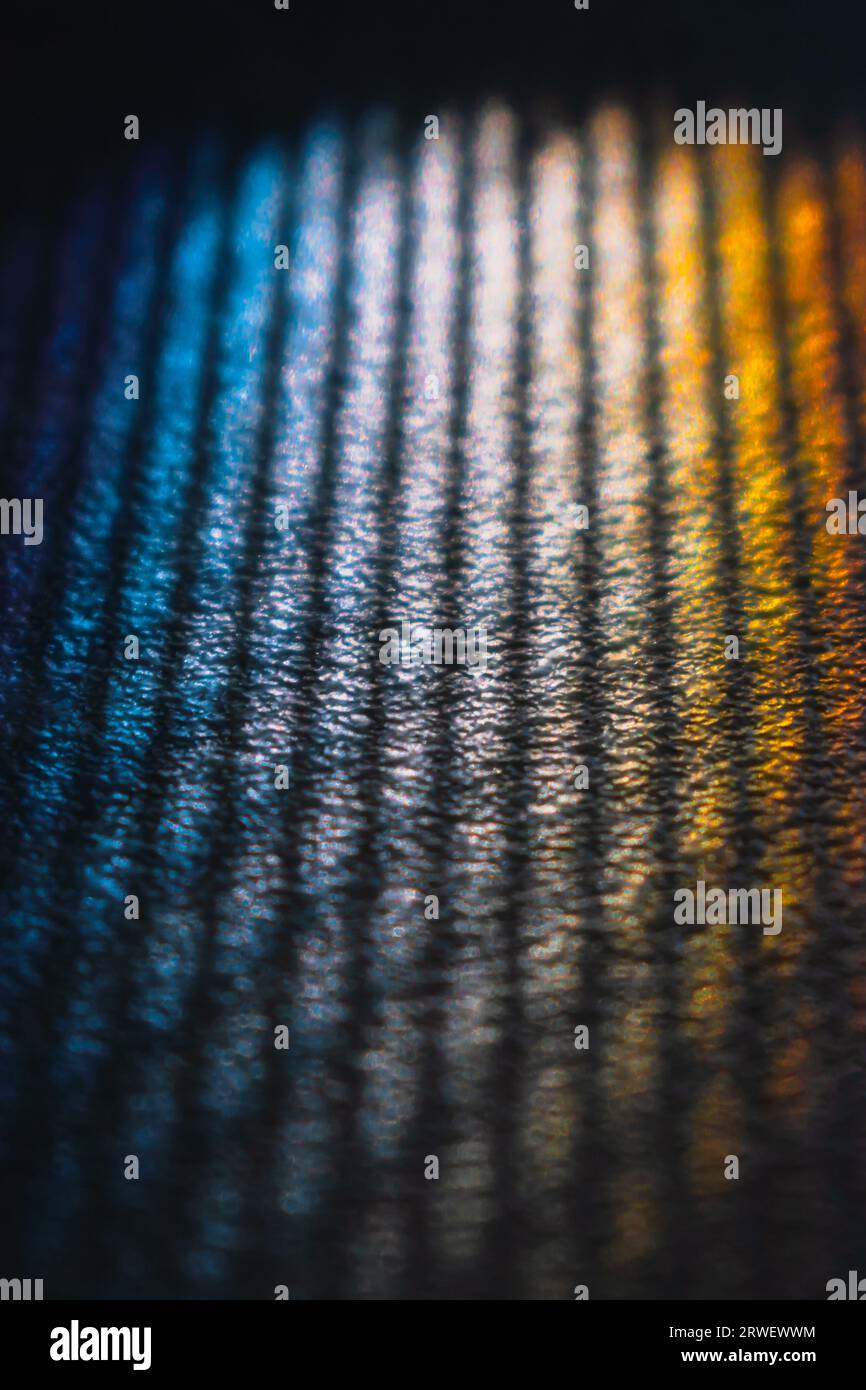 Sun catcher, prism of light on the ground through a grid reflected by a ...