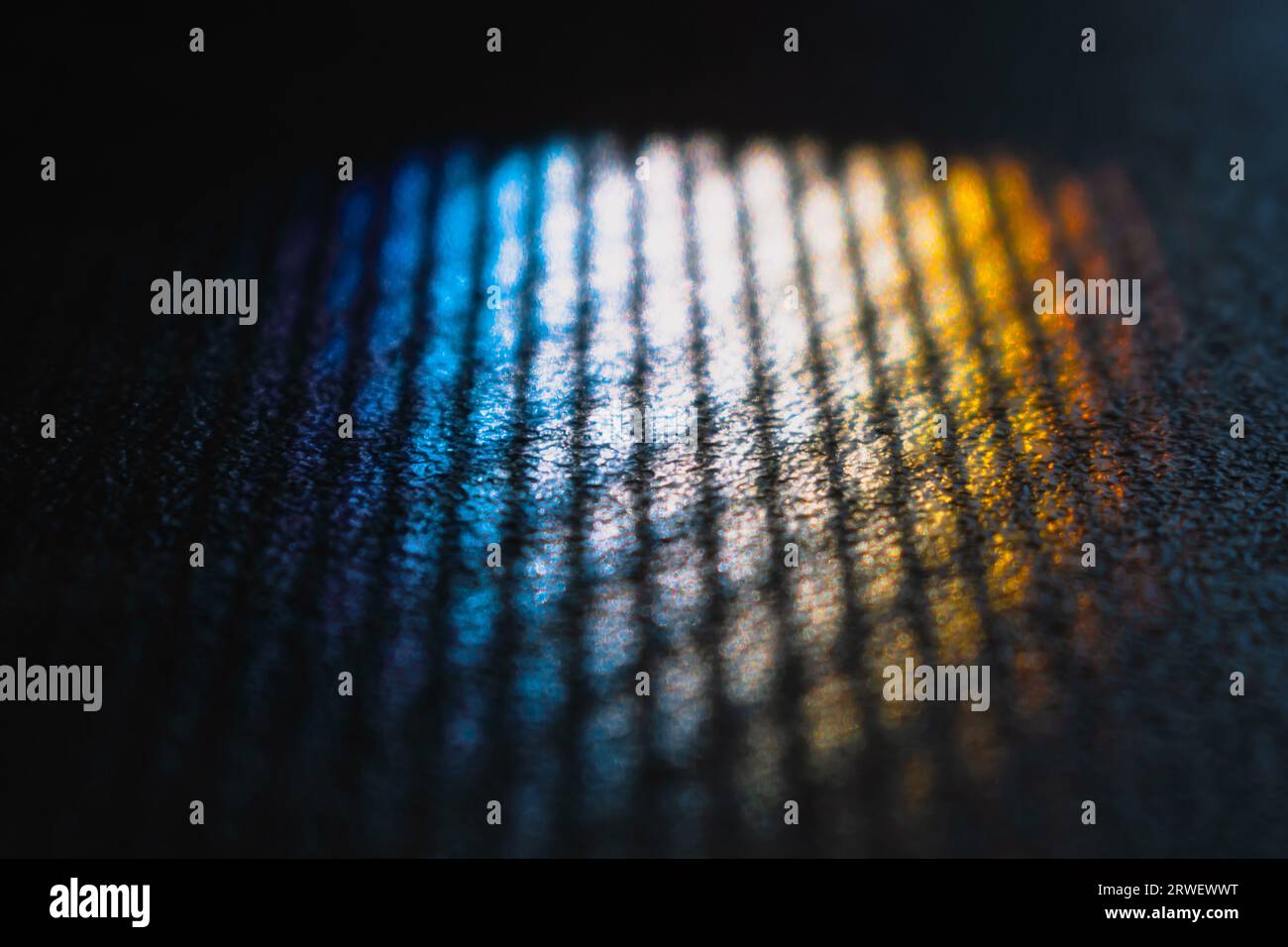 Sun catcher, prism of light on the ground through a grid reflected by a ...