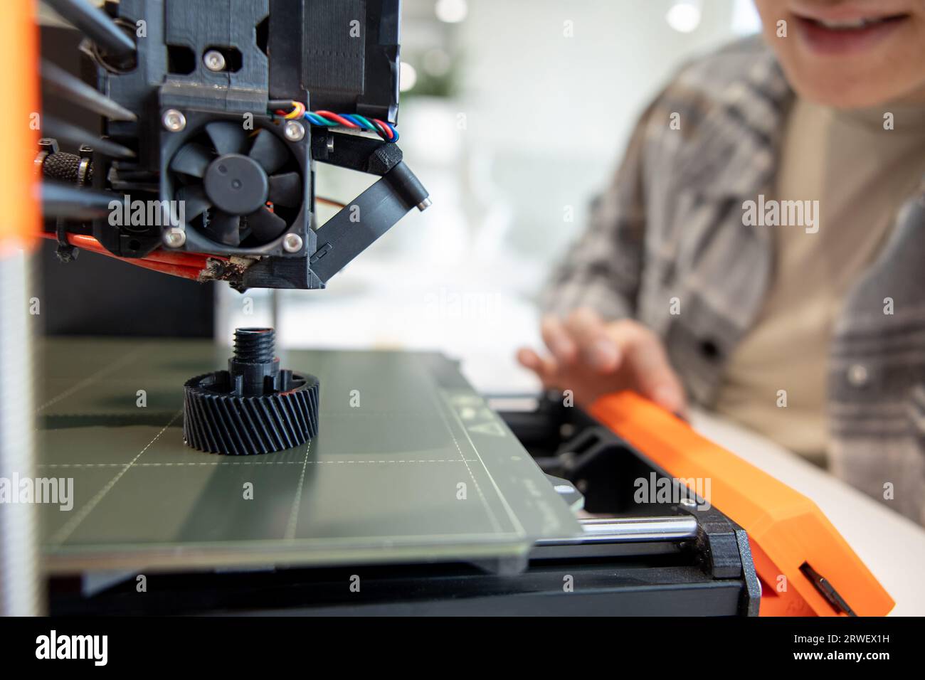 Man checking 3d printer, process of making things on 3d printer in ...