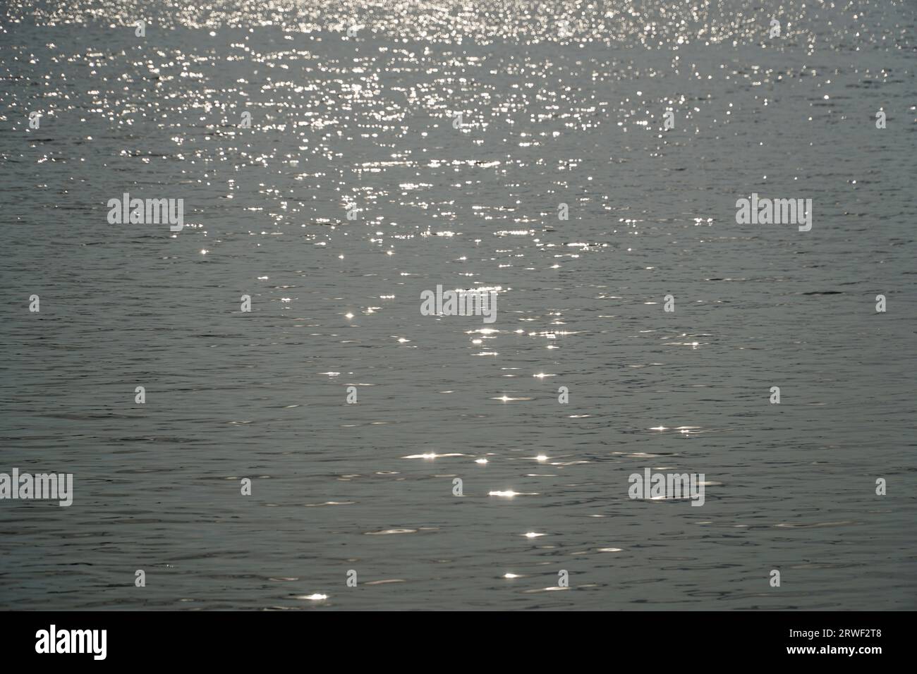 Sun reflecting in water surface Stock Photo - Alamy