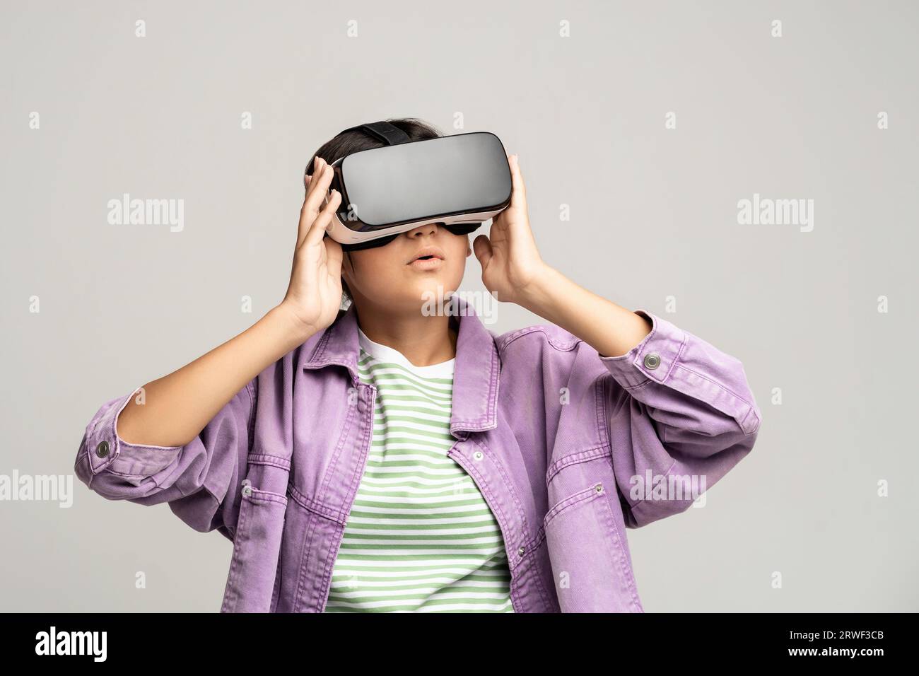 Teenager girl in virtual glasses goggles watching movie playing video ...