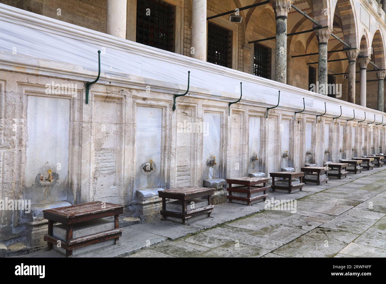 Wudu hands, feet and face washing ritual - special water taps next to ...