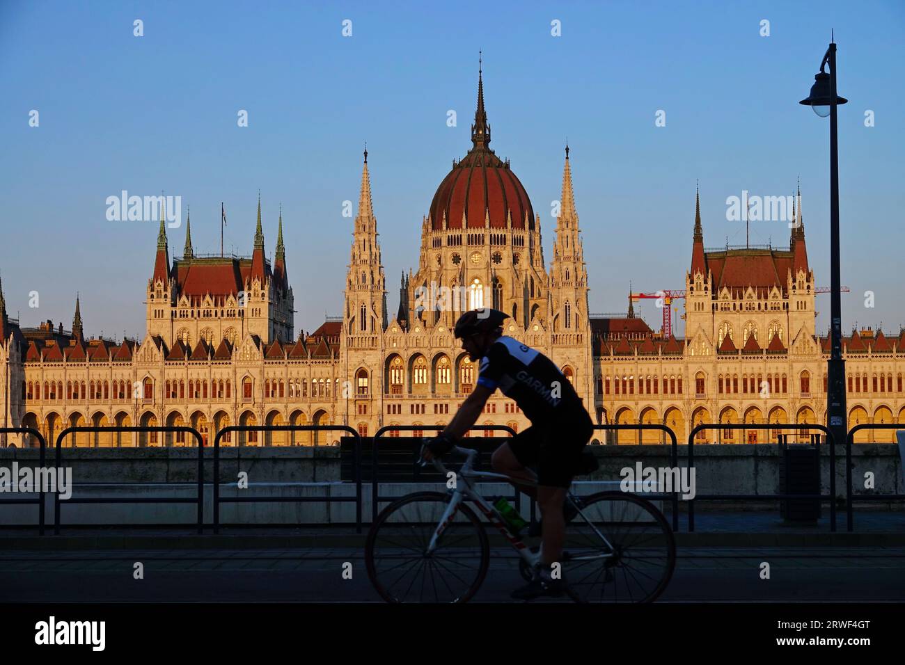 HUNGARY, BUDAPEST - August 21 ,2023: A cyclist rides in the back light ...