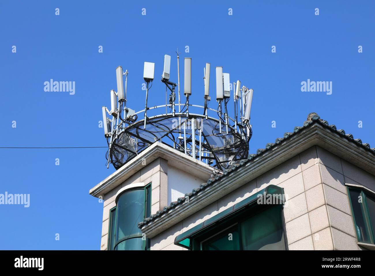 Base station in Korea. Mobile phone transmitters on building roof in ...