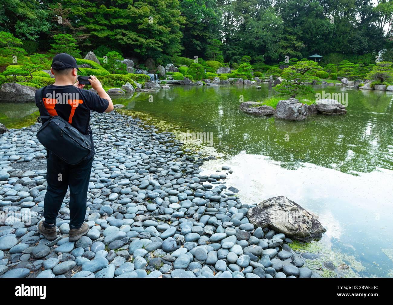 Tourist taking pictures in Ohori Park Japanese Garden, Kyushu region, Fukuoka, Japan Stock Photo ...