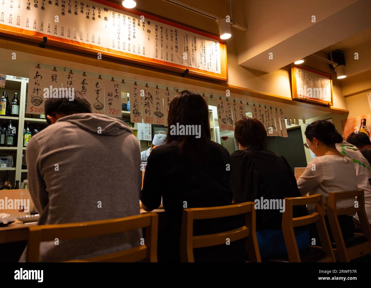 Guests sit in a sushi restaurant, Kyushu region, Fukuoka, Japan Stock ...