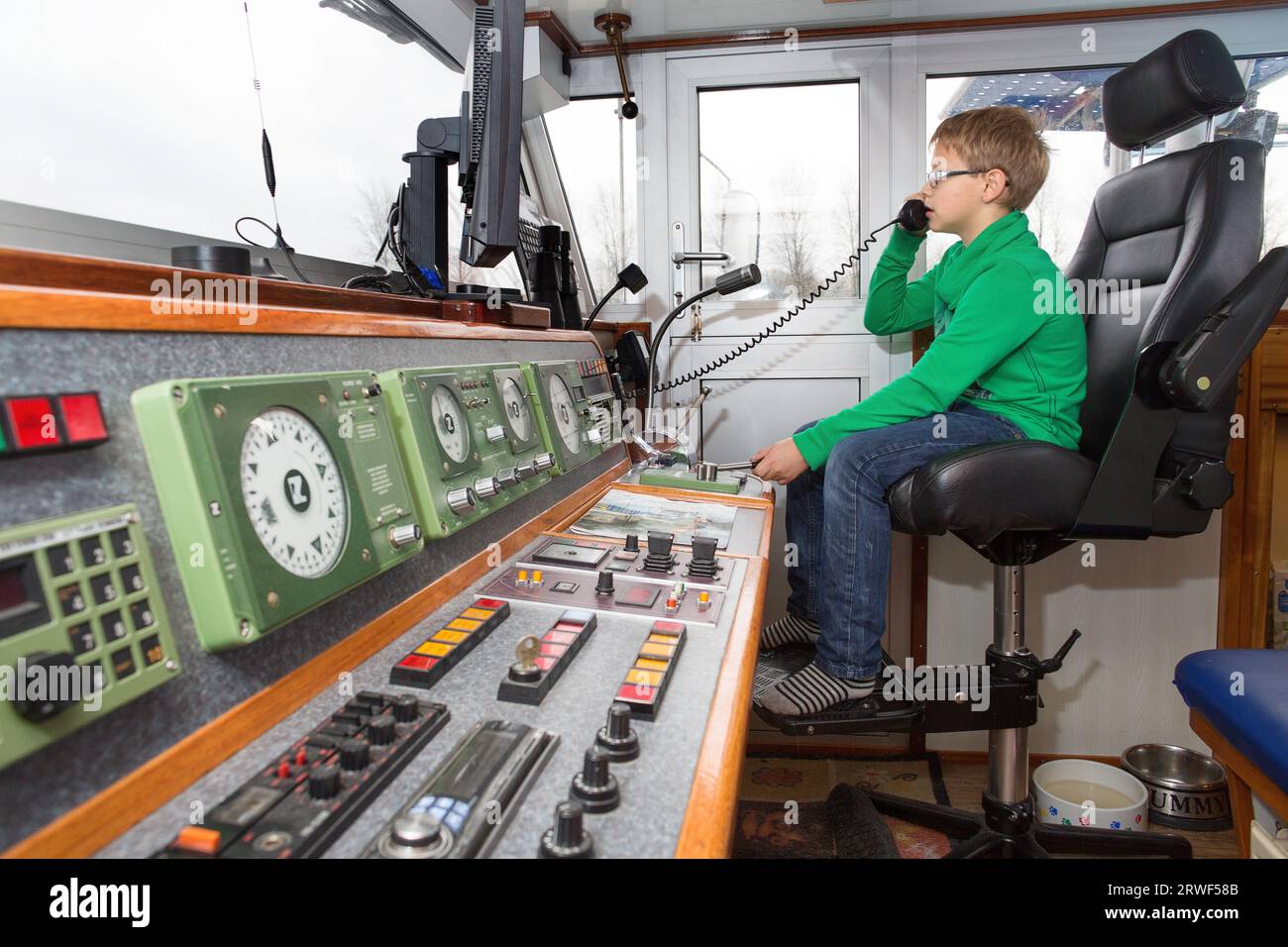 Young boy working in the wheelhouse on a ship. Netherlands 2014 ...
