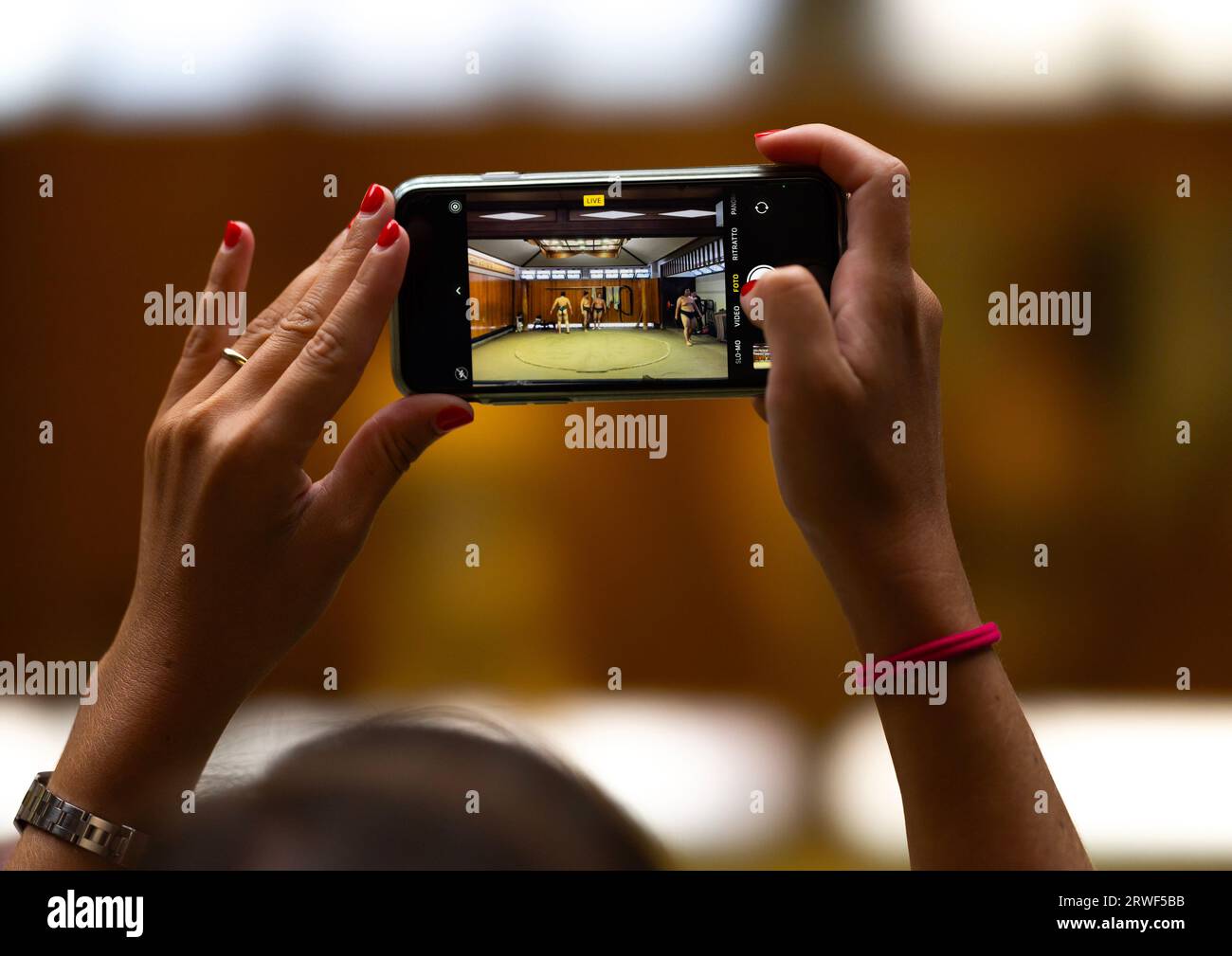 Tourist taking pictures with mobile phone in Tatsunami Beya sumo stable ...