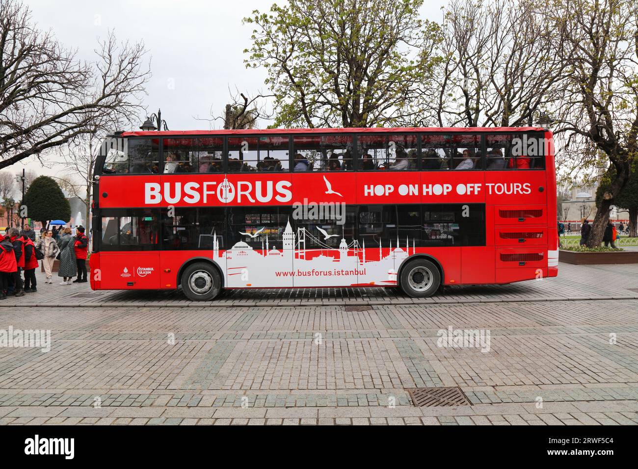 ISTANBUL, TURKEY - APRIL 11, 2023: Tourists ride hop on hop off bus ...