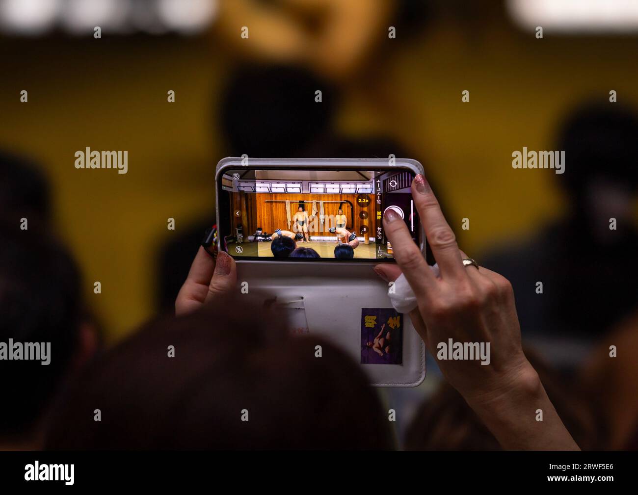 Tourist taking pictures with mobile phone in Tatsunami Beya sumo stable ...